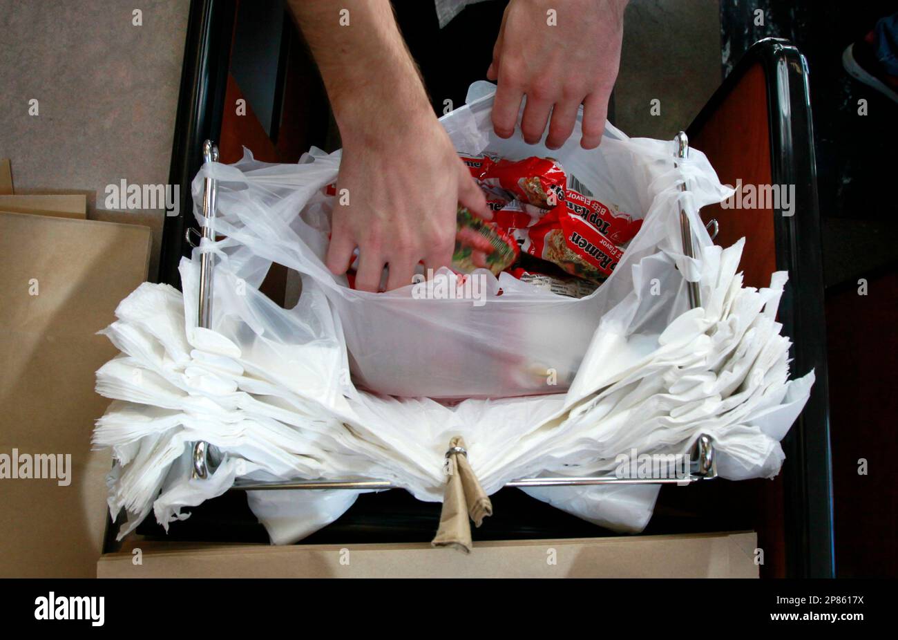 This Aug. 3, 2009 photo shows a clerk bagging groceries in plastic ...