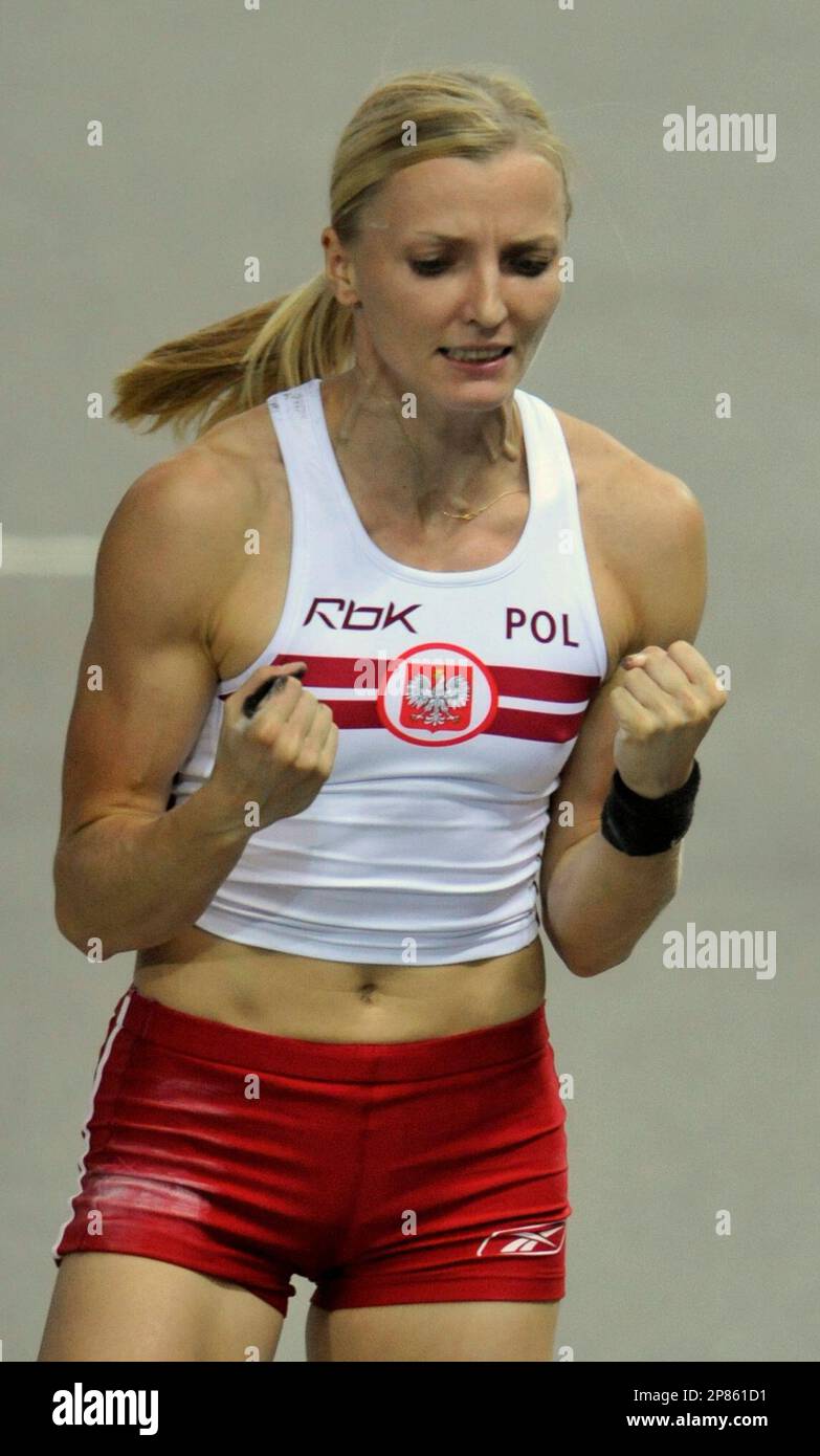 Poland's Anna Rogowska celebrates on her way to winning the gold medal ...