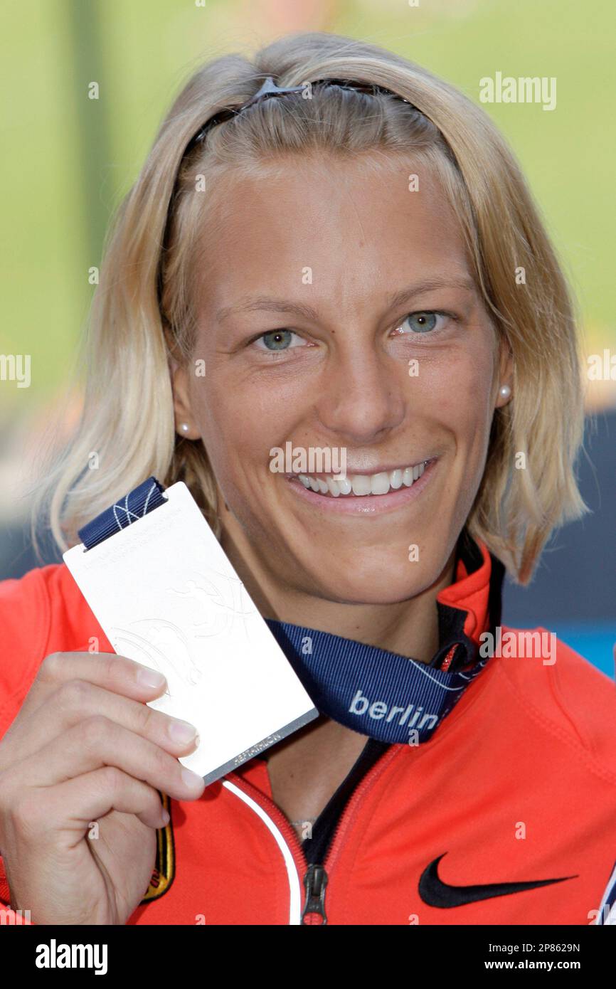 Germany's Jennifer Oeser smiles as she holds her silver medal during ...