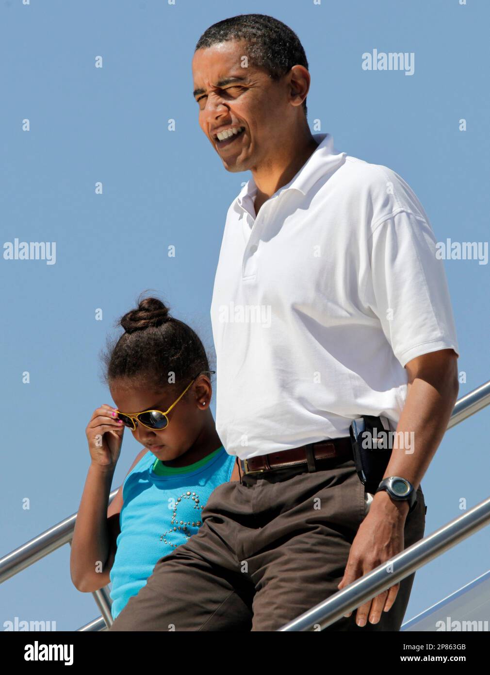 President Barack Obama and his daughter Sasha Obama, 8, walk down the ...