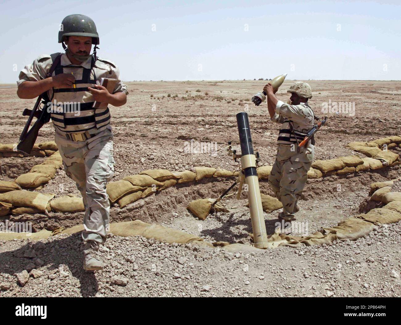 Iraqi Army soldiers fire a mortar round during a training mission in ...