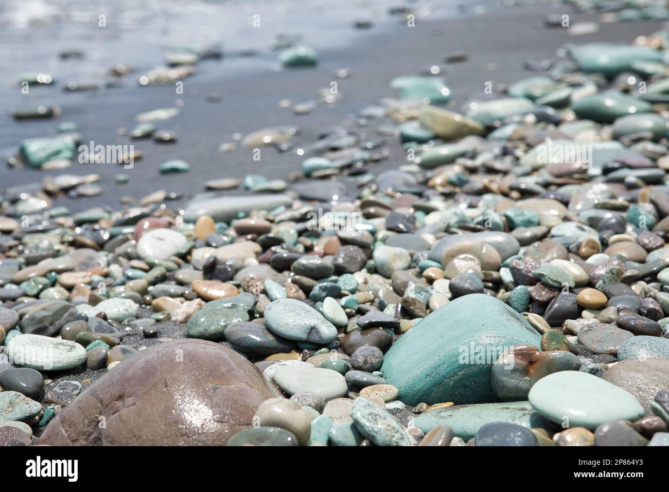 Close-up of blue stones on the beach of Pantai Batu Biru, the Blue ...