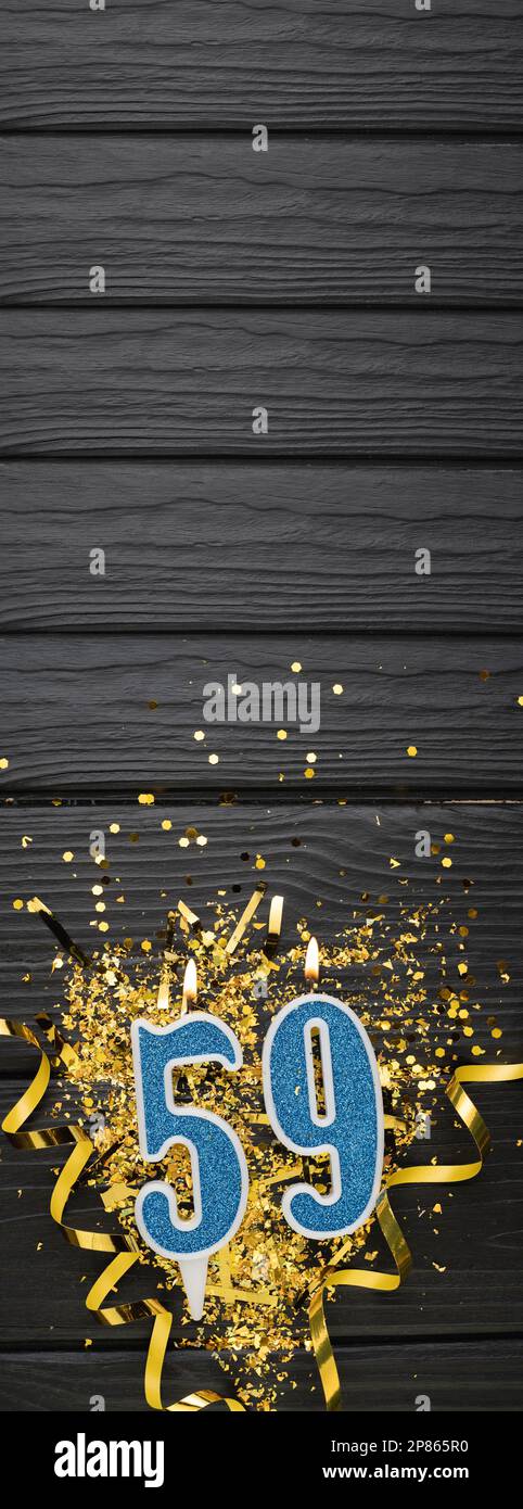Number 59 Blue Celebration Candle And Gold Confetti On Dark Wooden