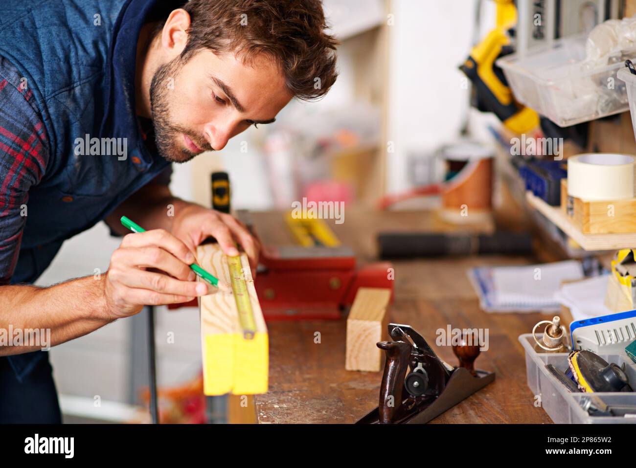 Handsome handyman looking measuring hi-res stock photography and images ...