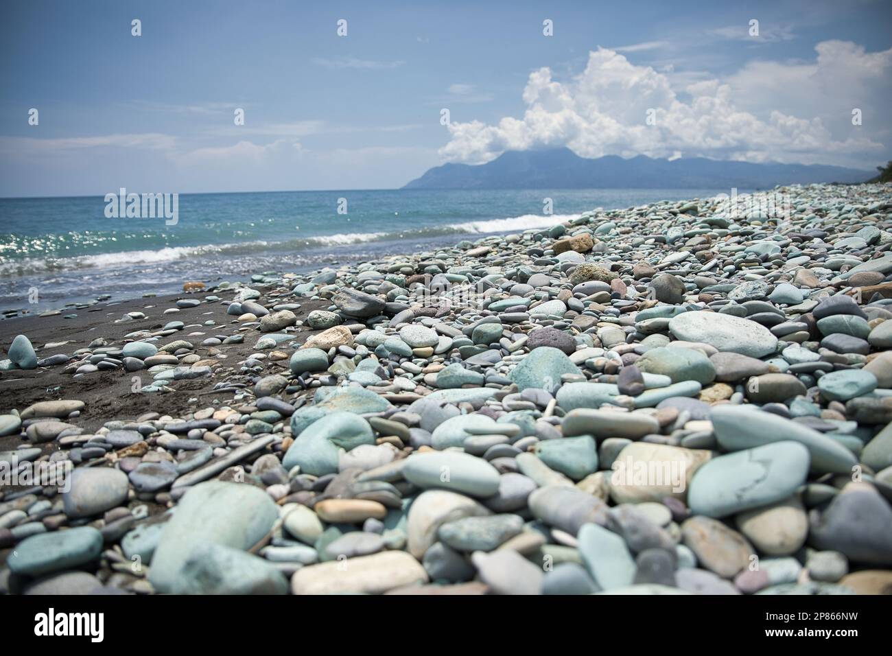 Close-up of blue stones on the beach of Pantai Batu Biru, the Blue ...