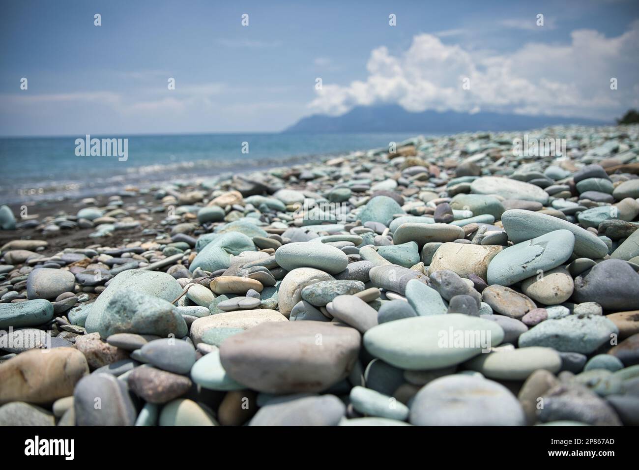 Close-up of blue stones on the beach of Pantai Batu Biru, the Blue ...