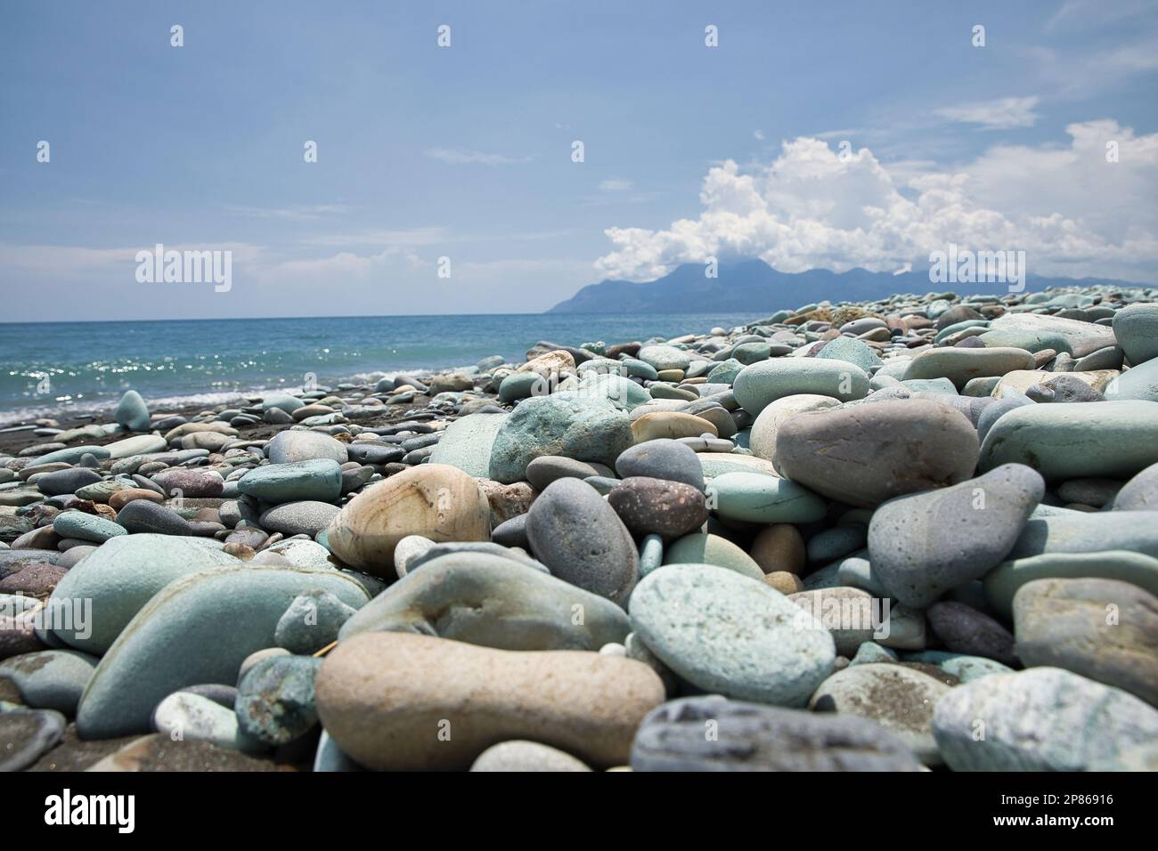 Close-up of blue stones on the beach of Pantai Batu Biru, the Blue ...