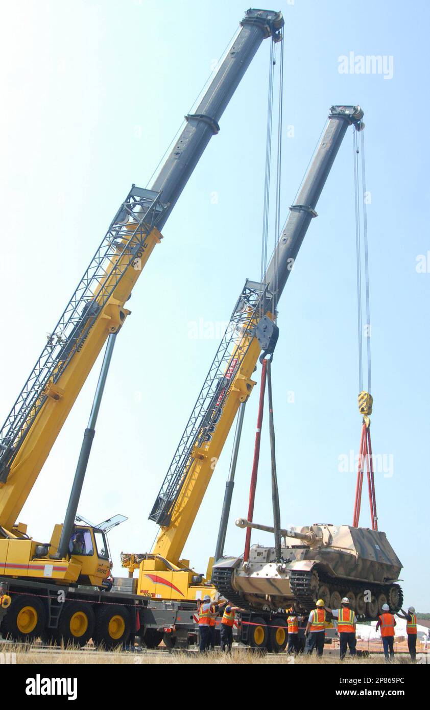 Workers guide a WWII-era German Jadgpanzer Elefant tank destroyer from ...