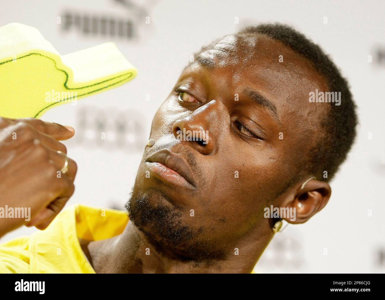 Jamaican sprinter Usain Bolt poses for photographs with a pair of 'Bolt ...