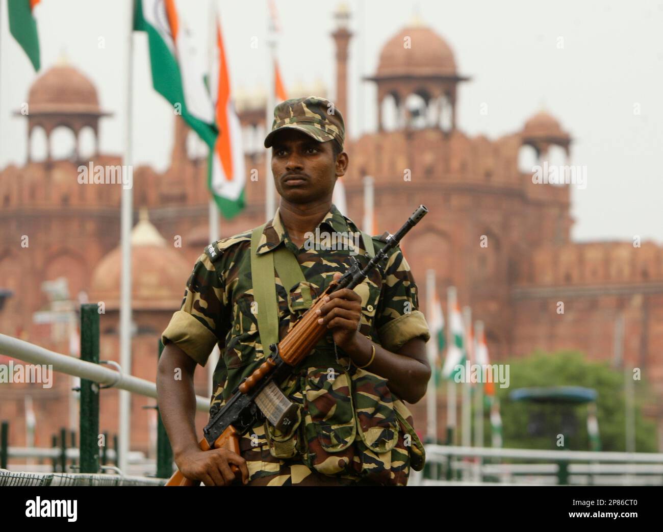 A paramilitary soldier stands guard in the backdrop of the Red Fort ...