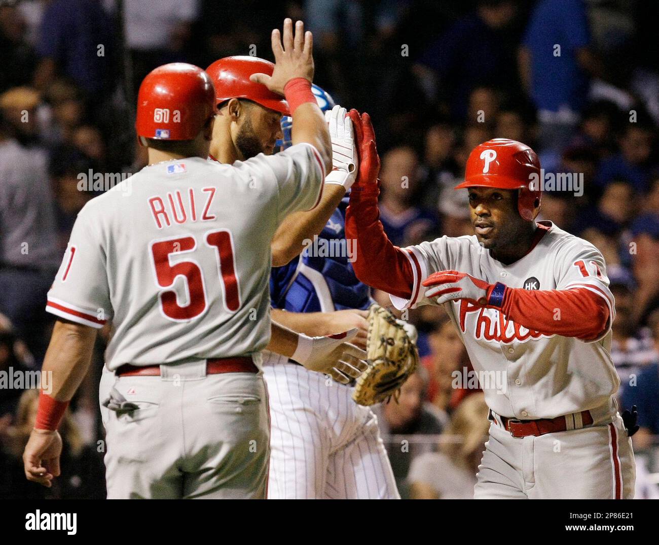 Philadelphia Phillies' Jimmy Rollins, right, is greeted at home plate ...