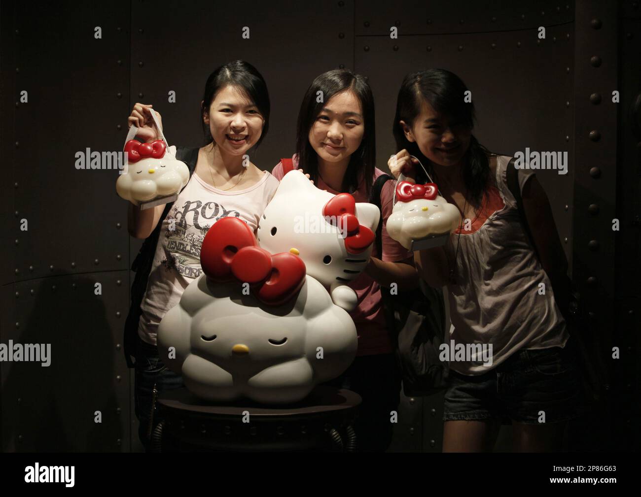 Visitors pose at the KITTY LAB exhibition in Hong Kong Wednesday, Aug ...