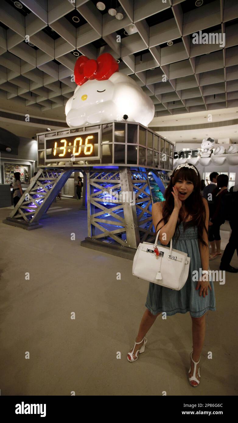 A visitor poses at the KITTY LAB exhibition in Hong Kong Wednesday, Aug ...