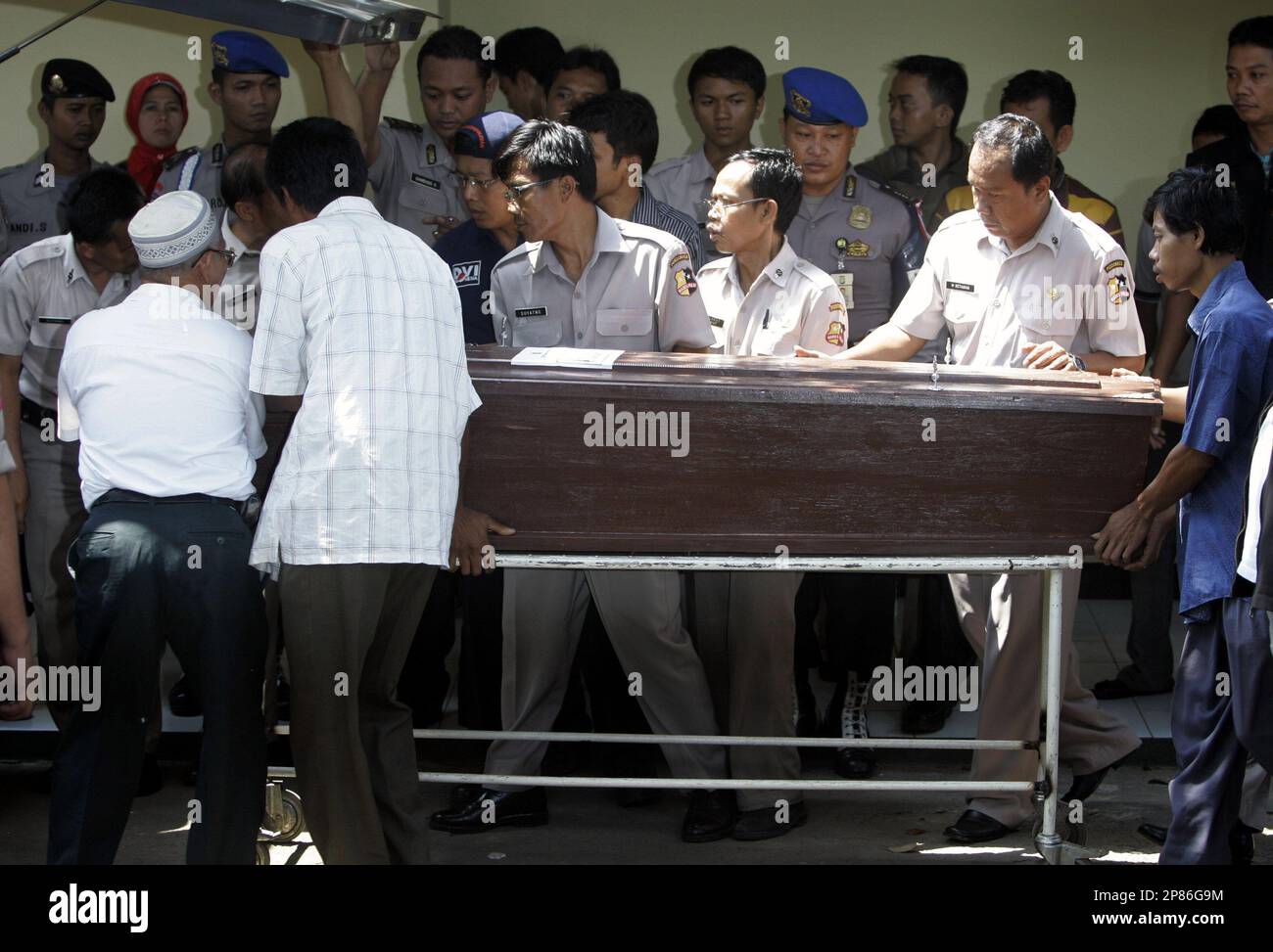 Workers wheel the coffin of Dani Dwi Permana, the suicide bomber who ...