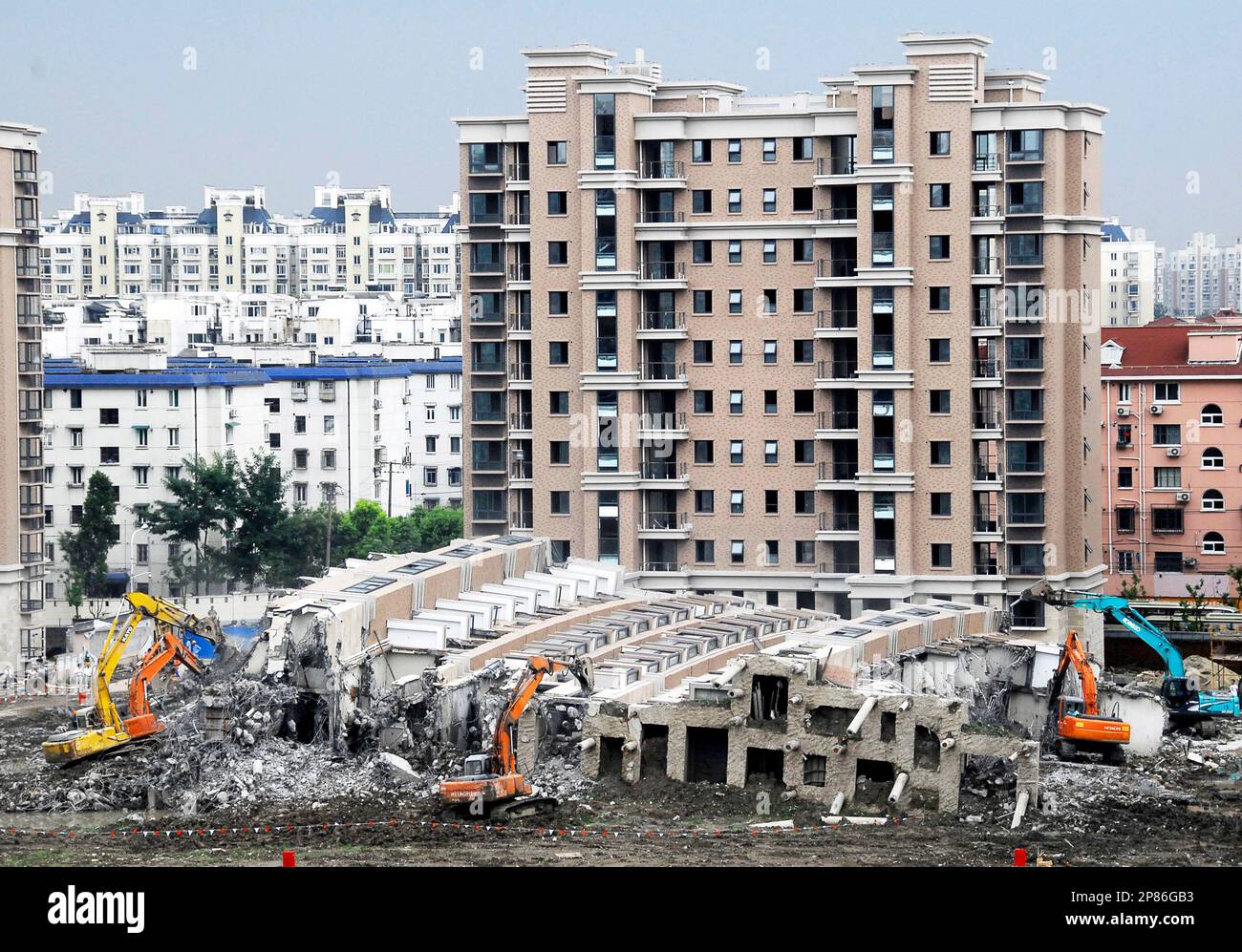 Excavators work to demolish a collapsed 13-story apartment building ...