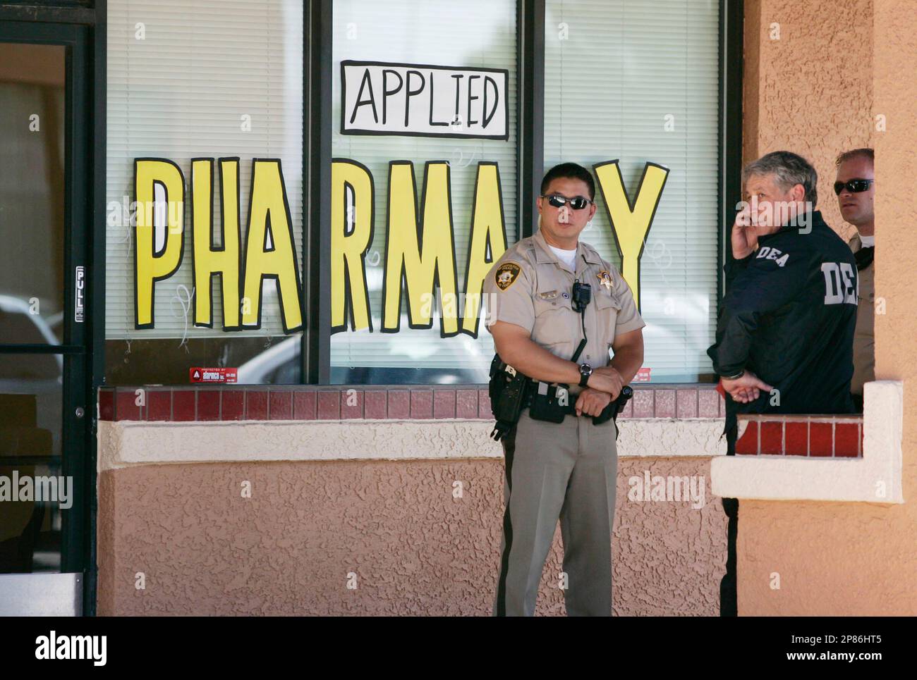 Las Vegas Metro Police officers and the DEA stand outside Applied ...