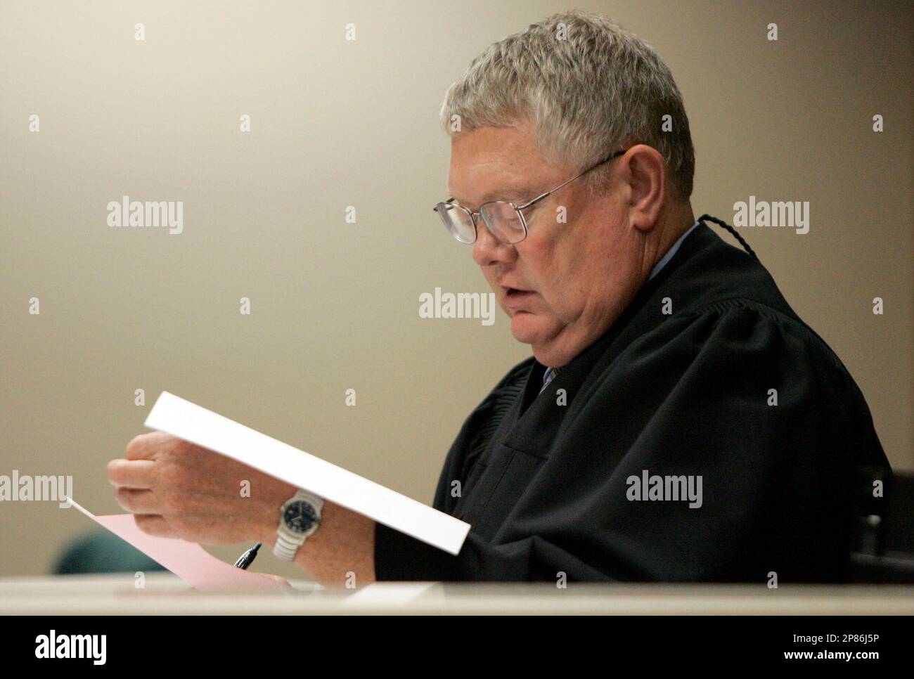 Judge Donald A. Poppy looks over paperwork during a felony false ...