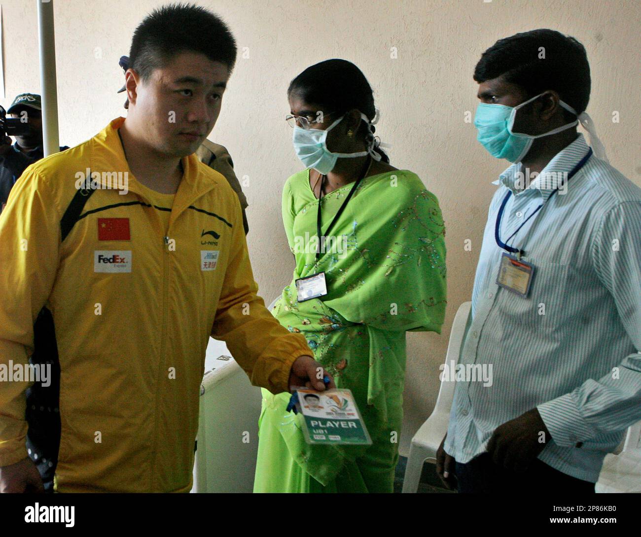 Indian police officials wearing protective masks look on as a Chinese ...
