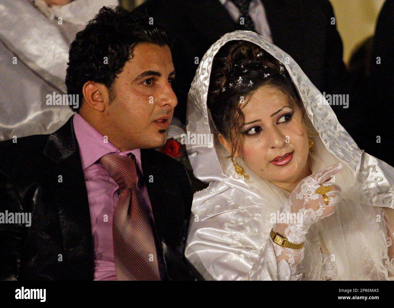 An Iraqi couple attends a mass wedding ceremony in Baghdad, Iraq ...