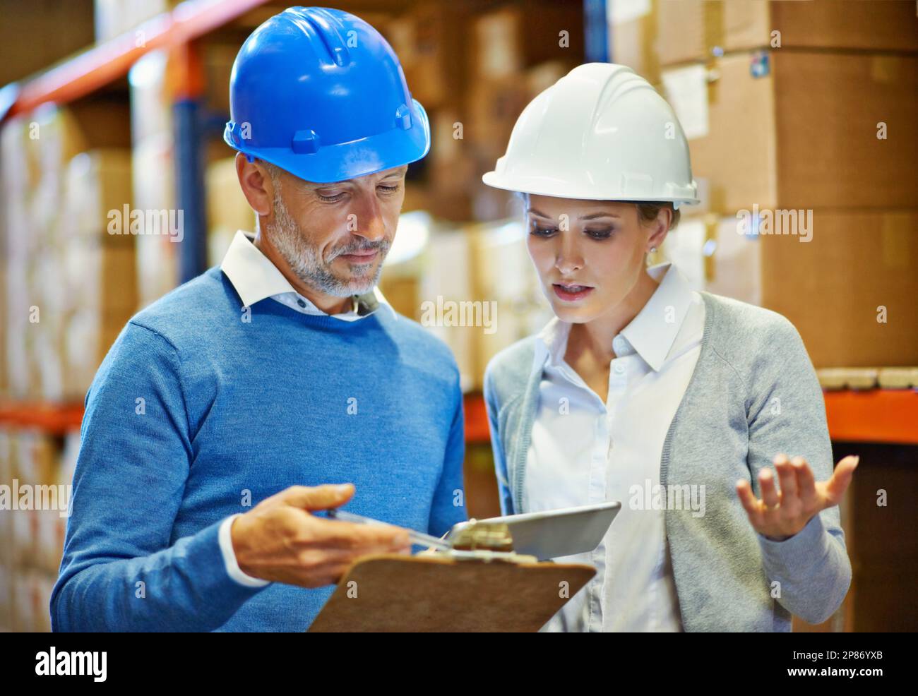 Going over the discrepancies in their figures. two people doing an ...