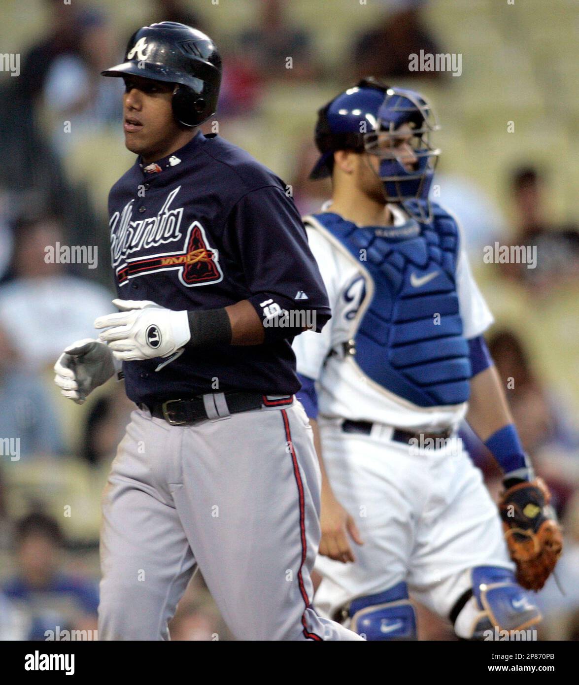 Atlanta Braves shortstop Yunel Escobar, left, scores a run off a single ...