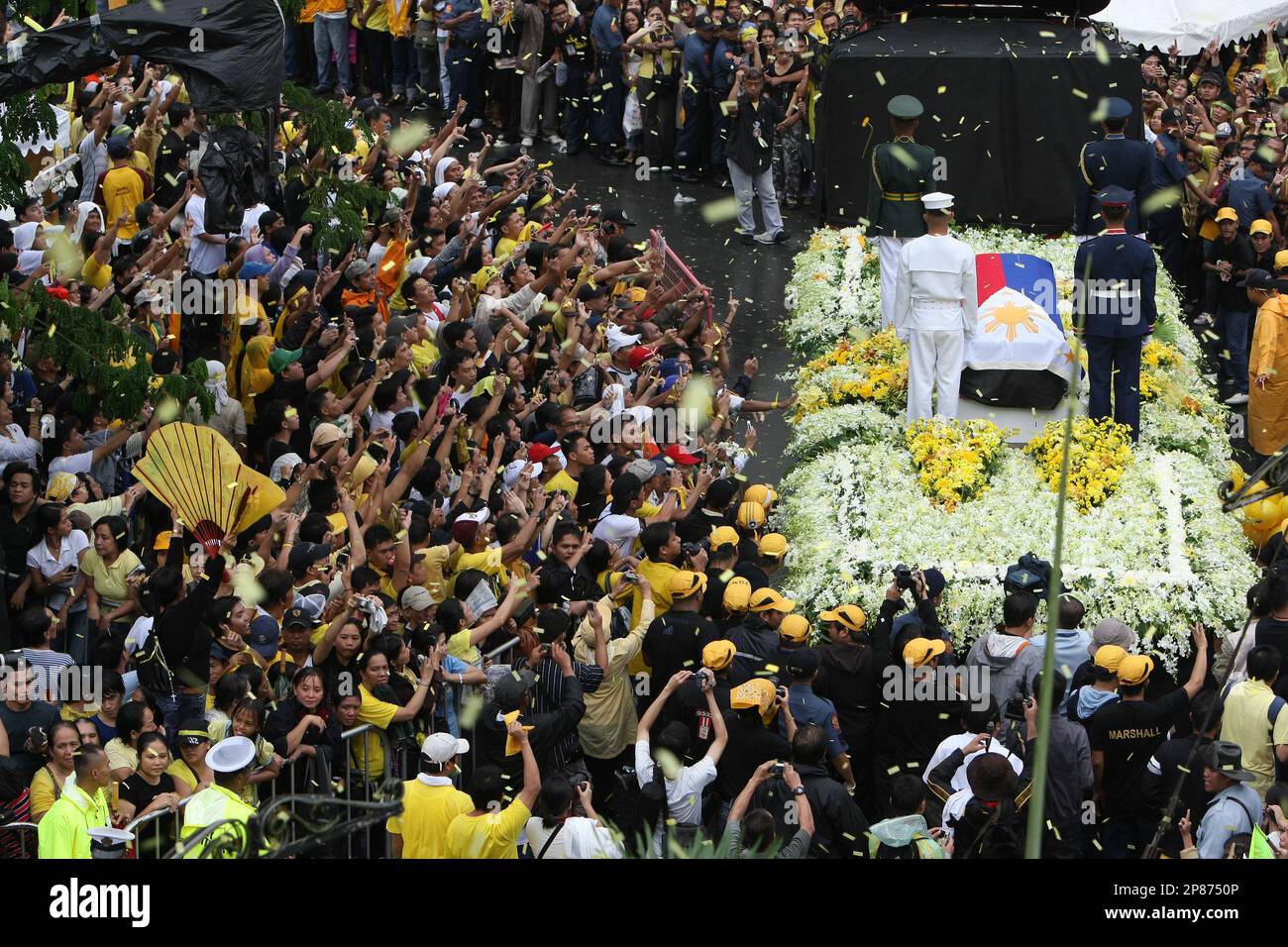Confetti is showered from above as the casket containing the remains of ...