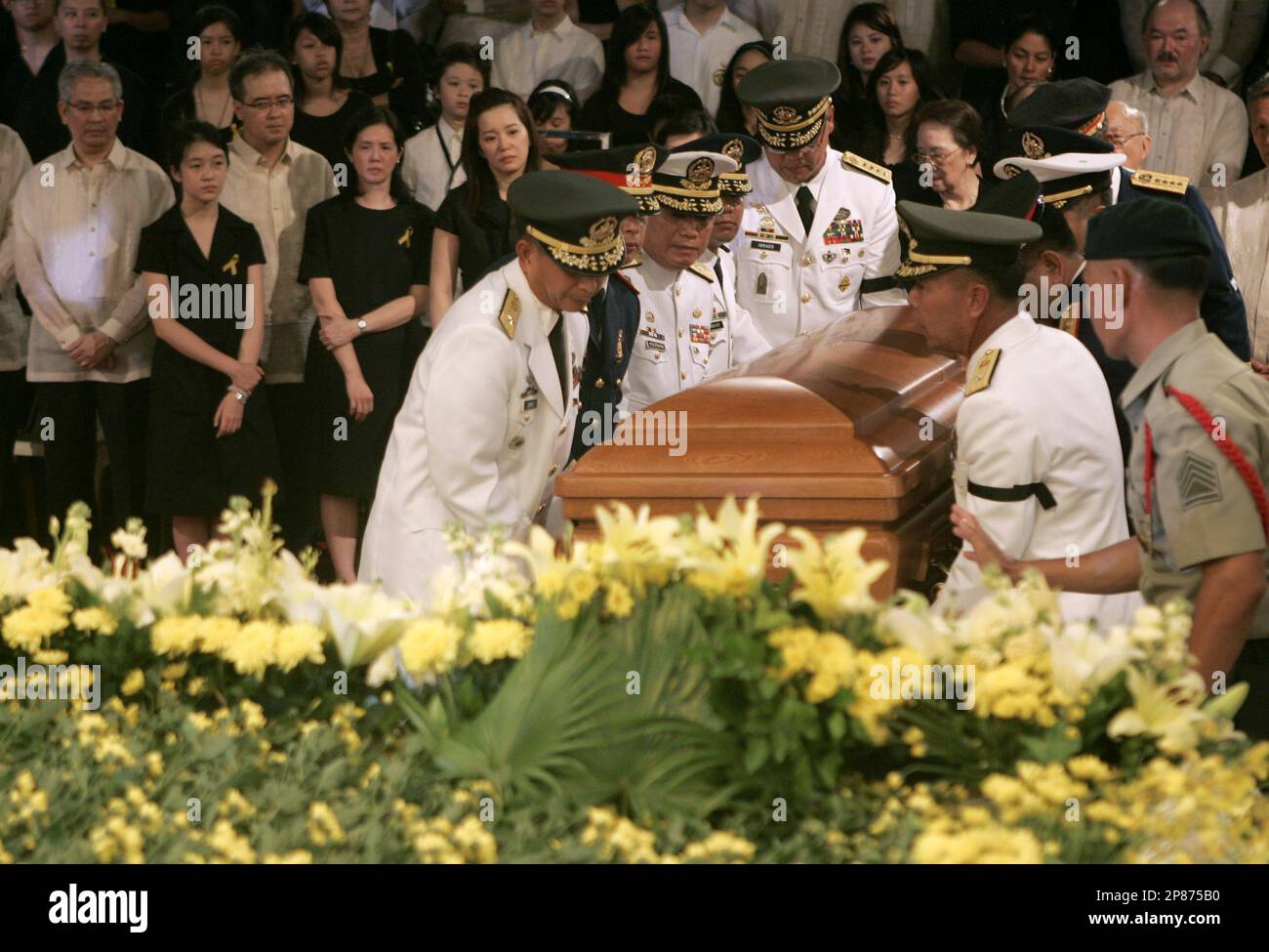 Military officers carry the casket of former Philippine President ...