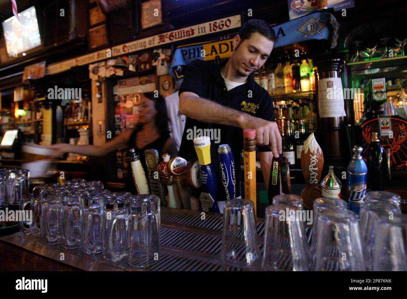 Bartender Mark Foran, right, and Jennifer Bermel pour and serve drinks ...