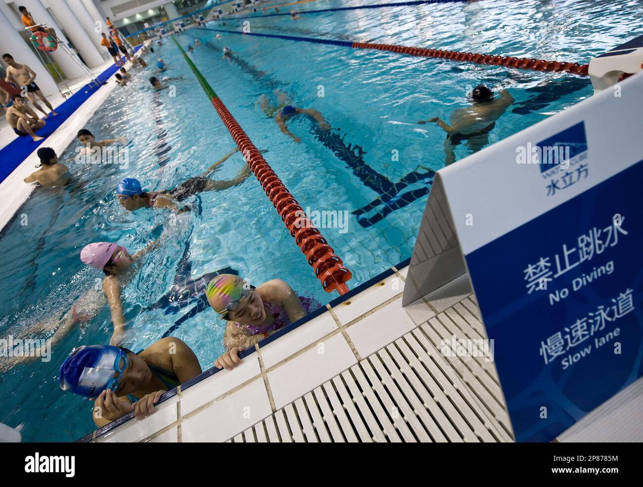 Visitors swim in the training pool at the National Aquatics Center ...
