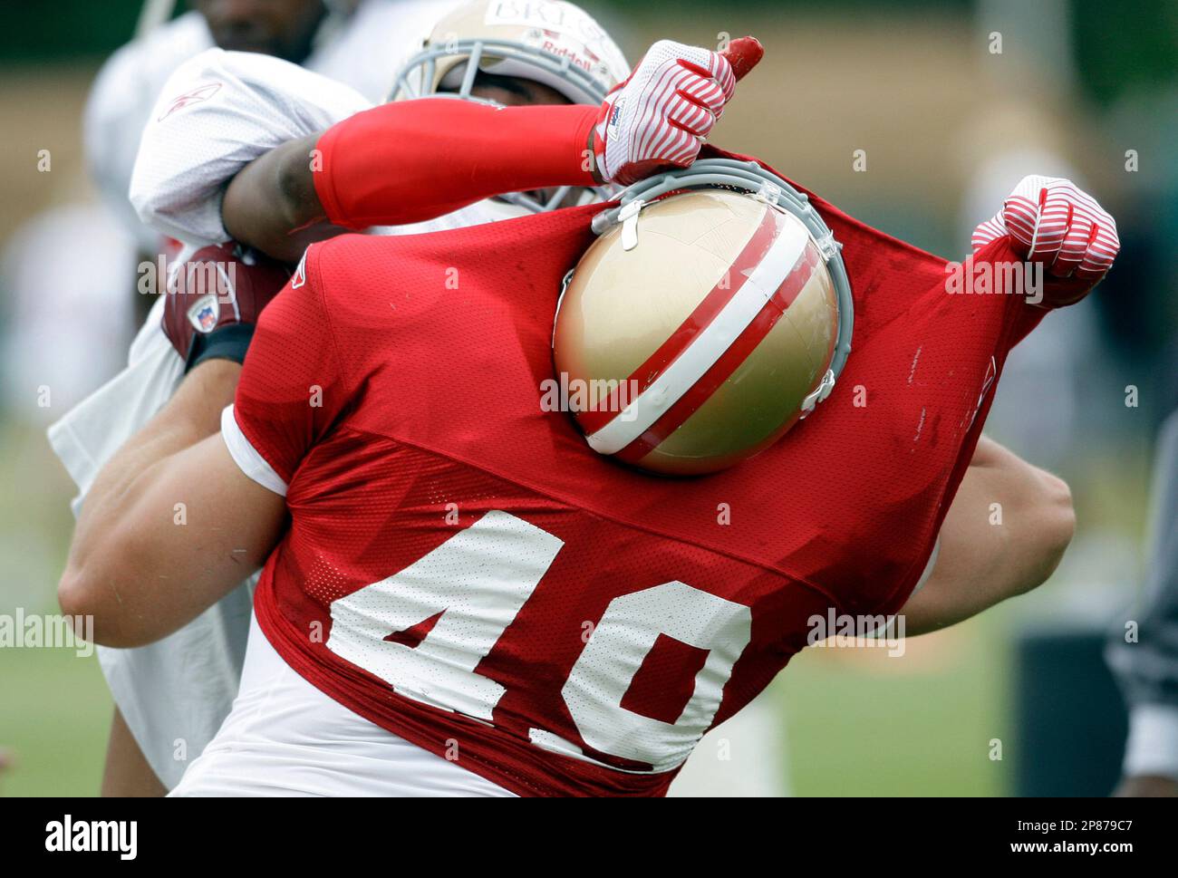 San Francisco 49ers linebacker Diyral Briggs, rear, and tight end Joe ...