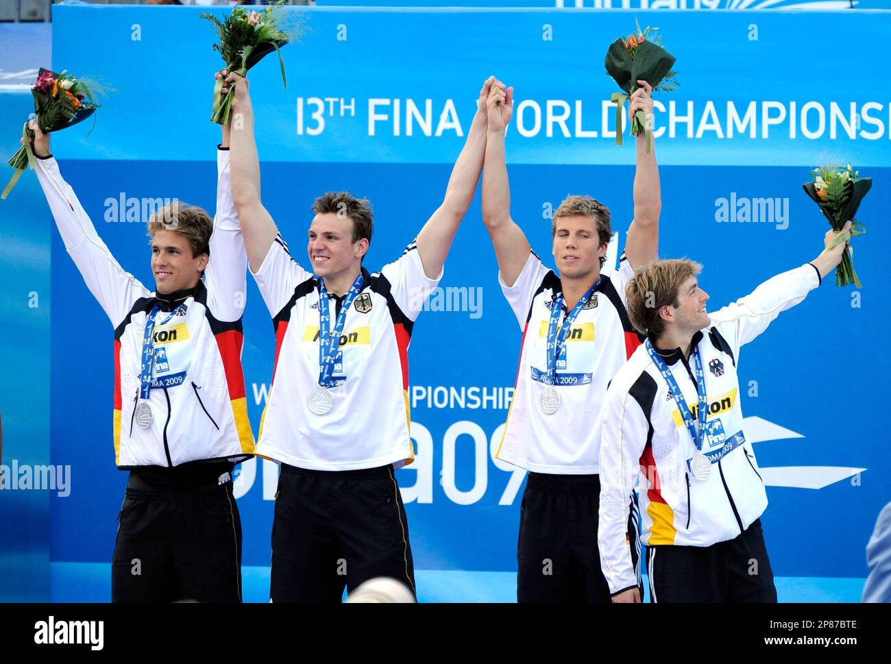 The German relay team celebrates after winning the silver medal of the ...