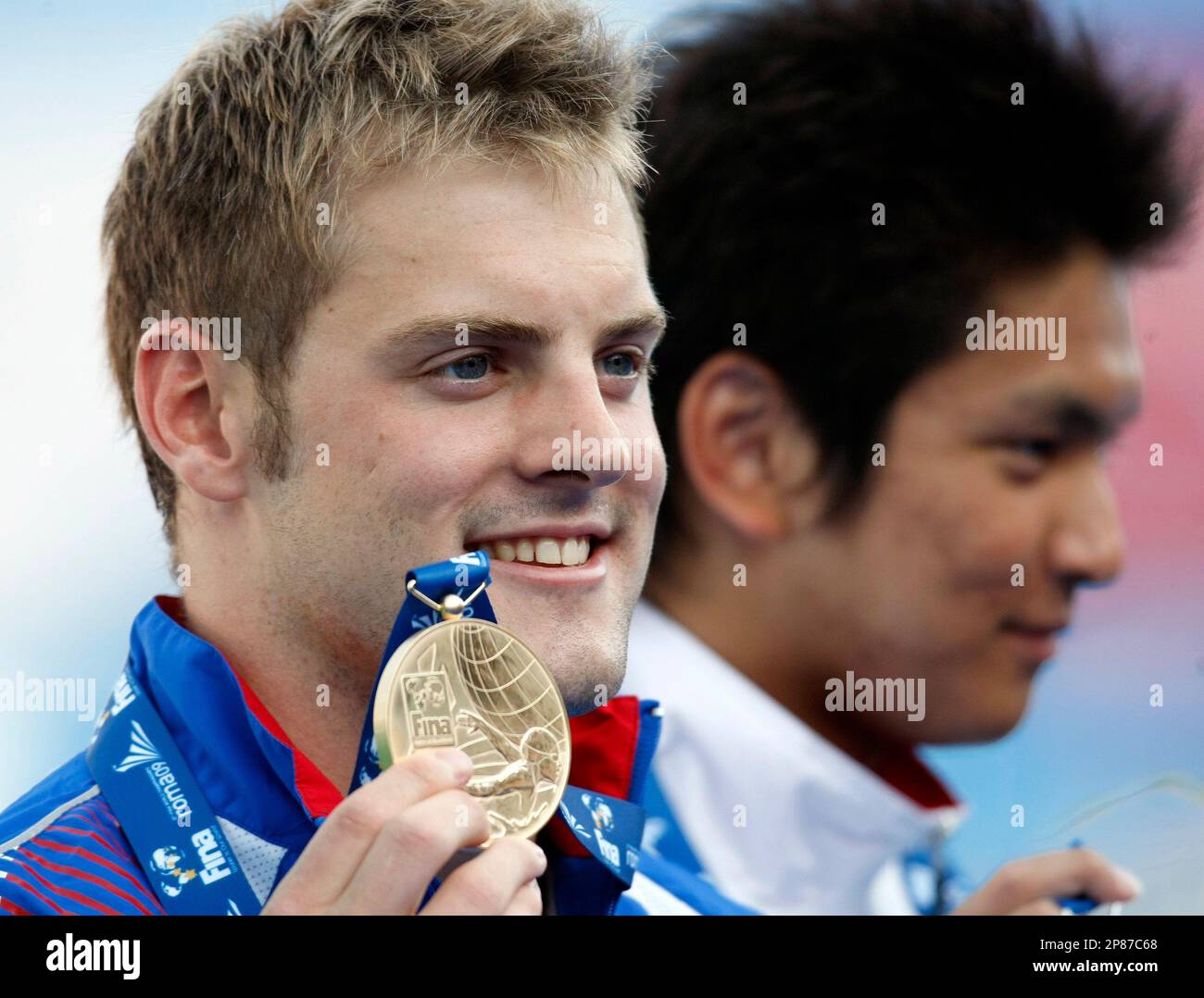 Britain's Liam Tancock shows the gold medal of the Men's 50m Backstroke ...
