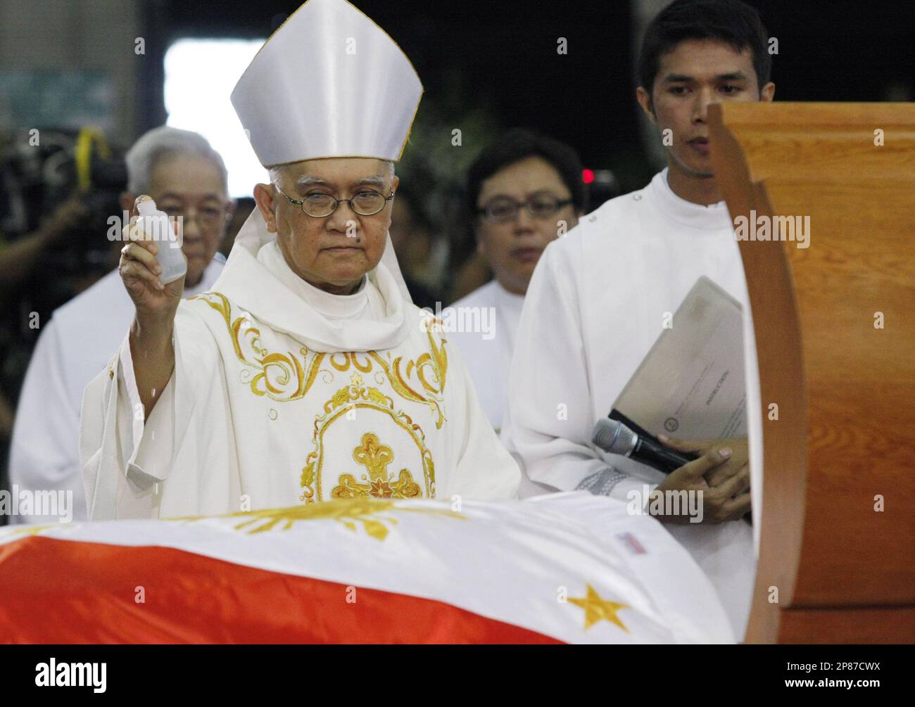 Filipino Bishop Angel Lagdameo blesses the casket of the late ...
