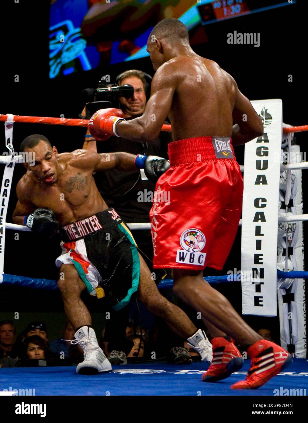 Devon Alexander, right, knocks Junior Witter, of Britain, into the ...