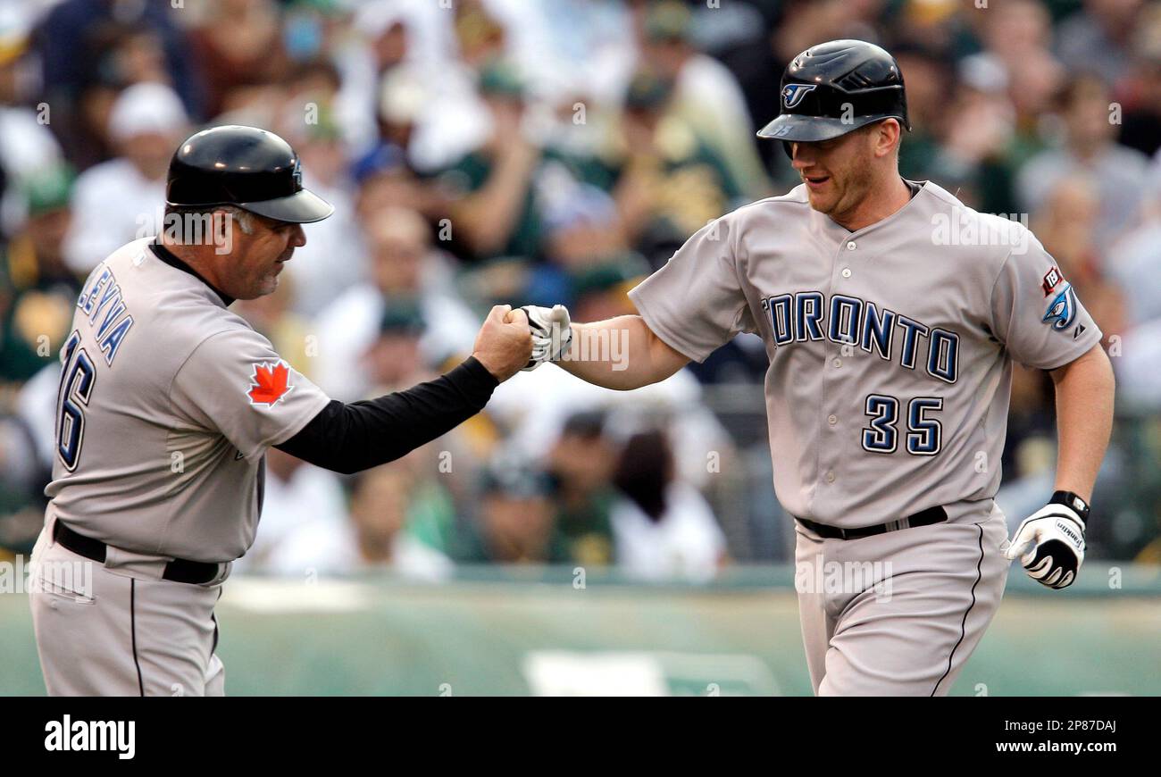 Toronto Blue Jays' Lyle Overbay, right, is congratulated by third base ...