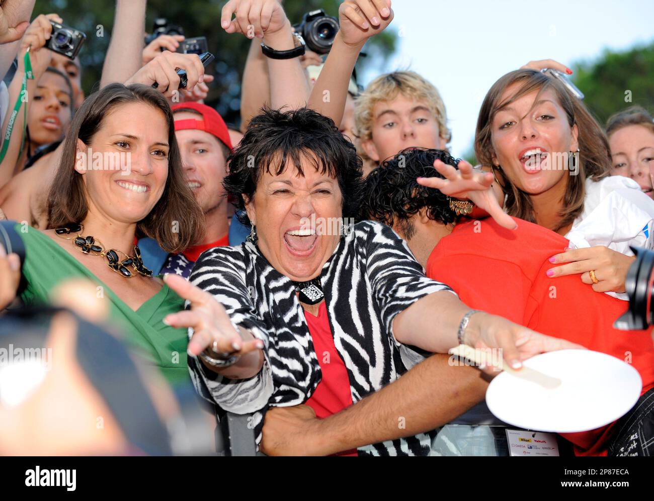 The mother of Michael Phelps, Debbie, reaches out for her son as they ...
