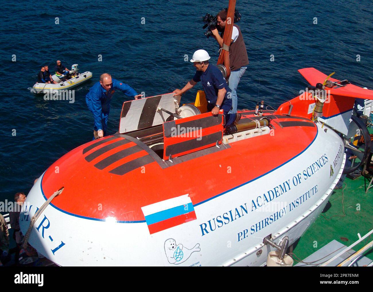 Russian Prime Minister Vladimir Putin, center left, climbs aboard a ...