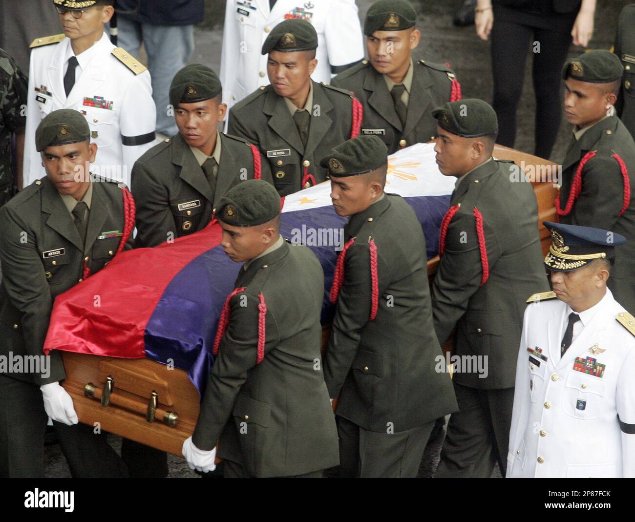 Filipino soldiers carry the casket of the late Philippine President ...