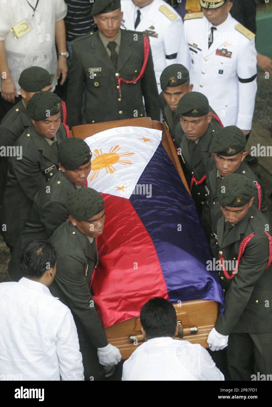 Filipino soldiers carry the casket of the late Philippine President ...