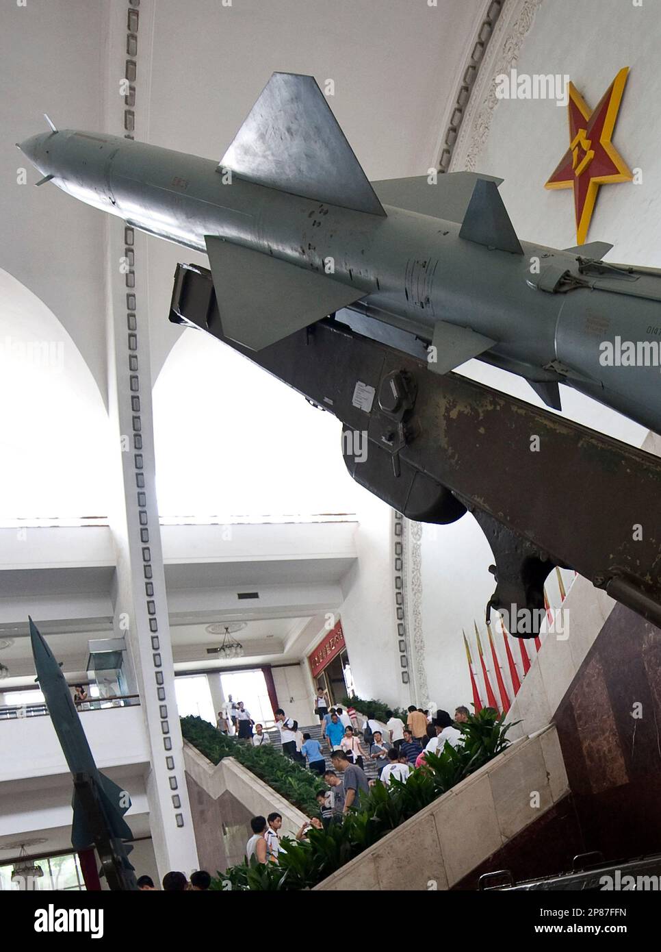 Visitors walk near the Chinese Hongqi-2 missiles on display at the ...