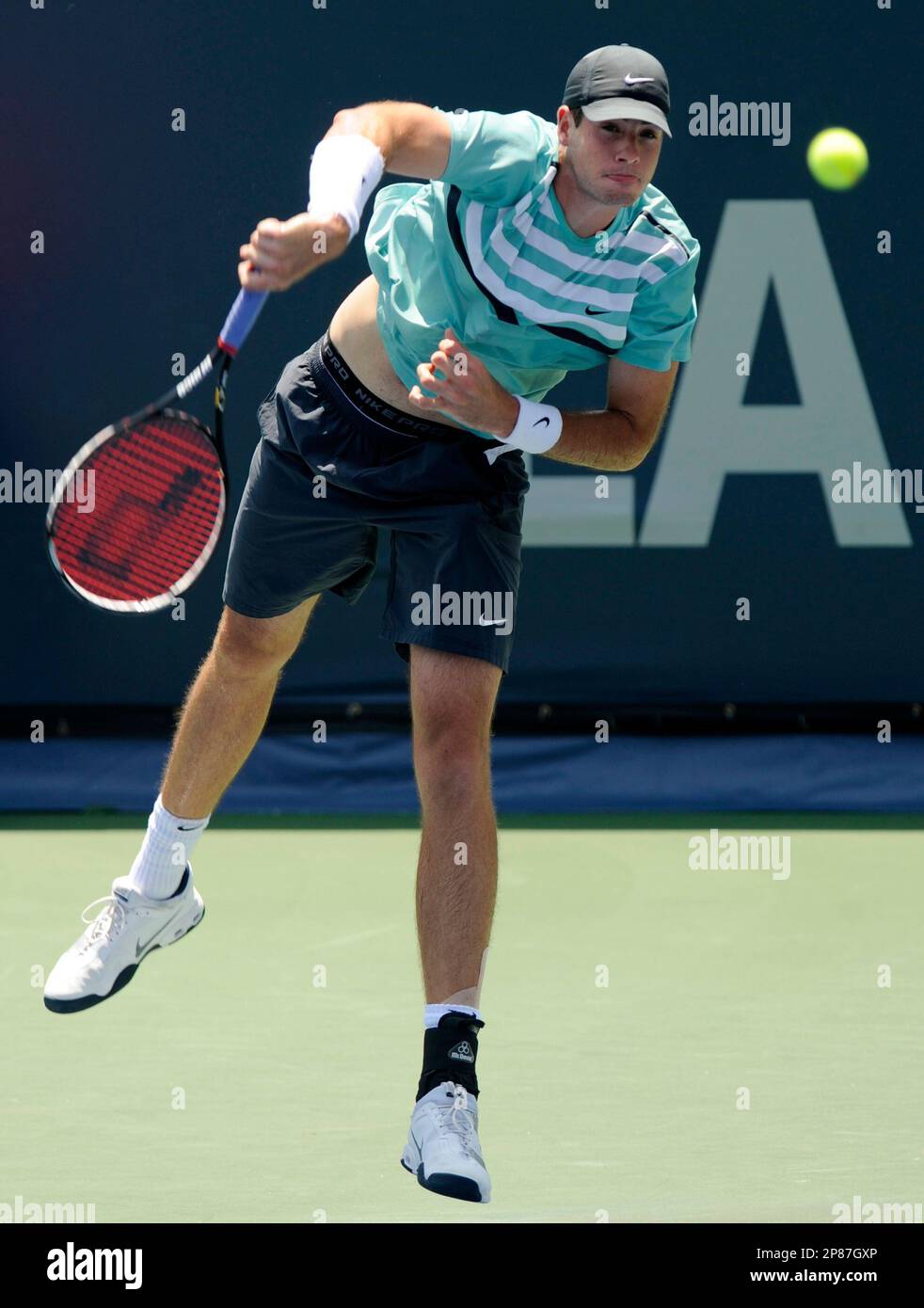 John Isner, of the United States, follows through on a serve during a ...