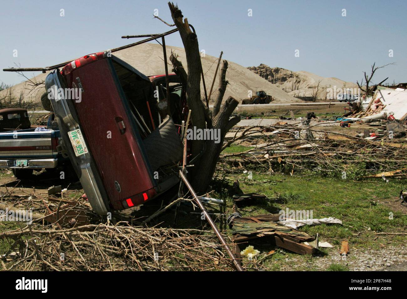 In this Sunday, May 11, 2008 photo, a pickup truck rests on its side ...
