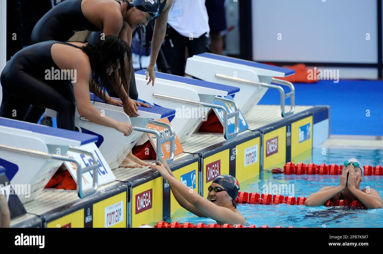 Members of the Chinese team celebrate after Pang Jiaying, in water ...