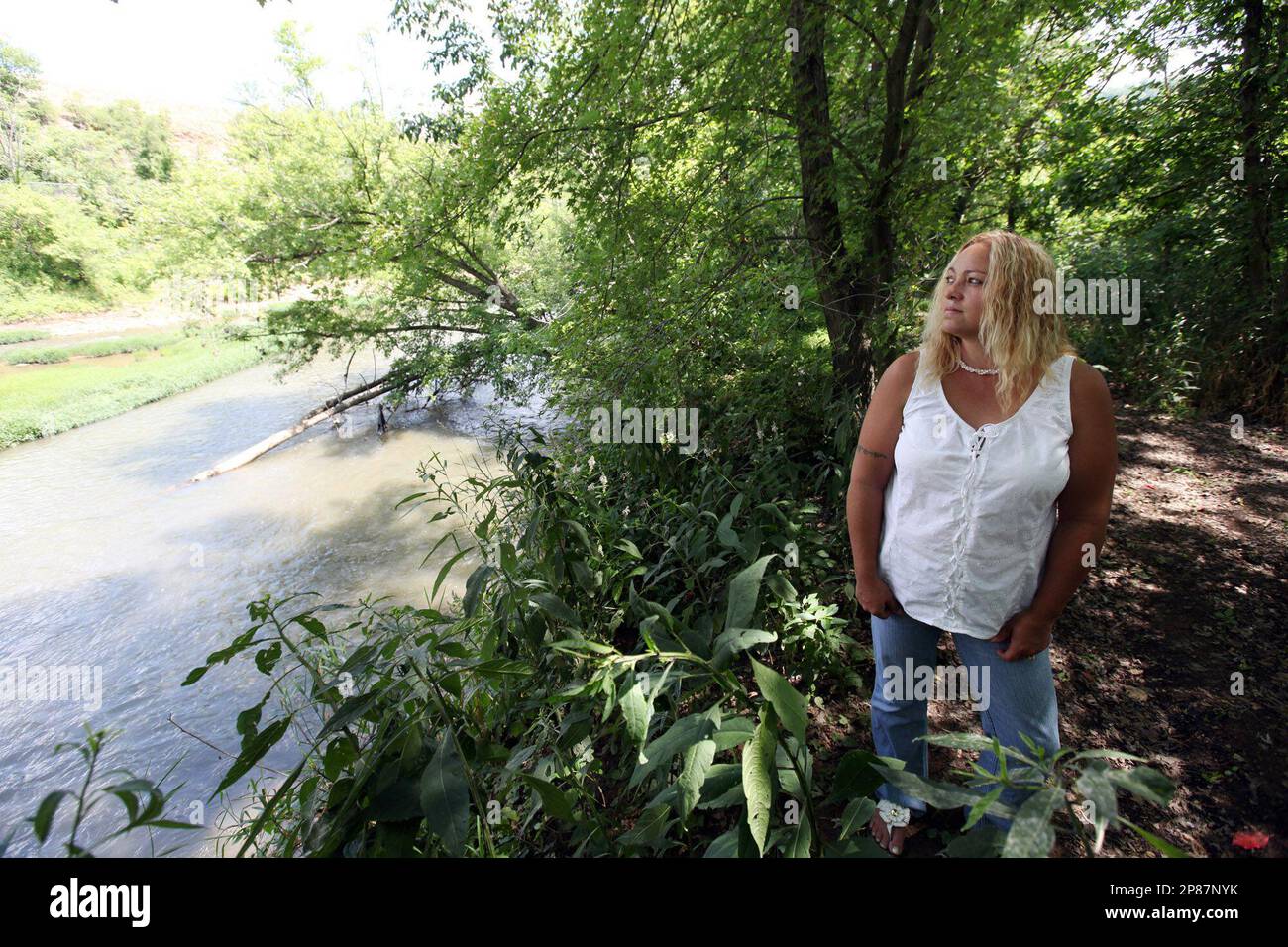 Rebecca Morlock, 41, of Spelter, WVa., stands on a brush-covered bank ...
