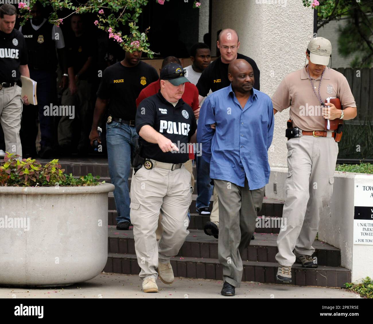 Federal agents escort suspects out of the FBI offices Wednesday, July ...