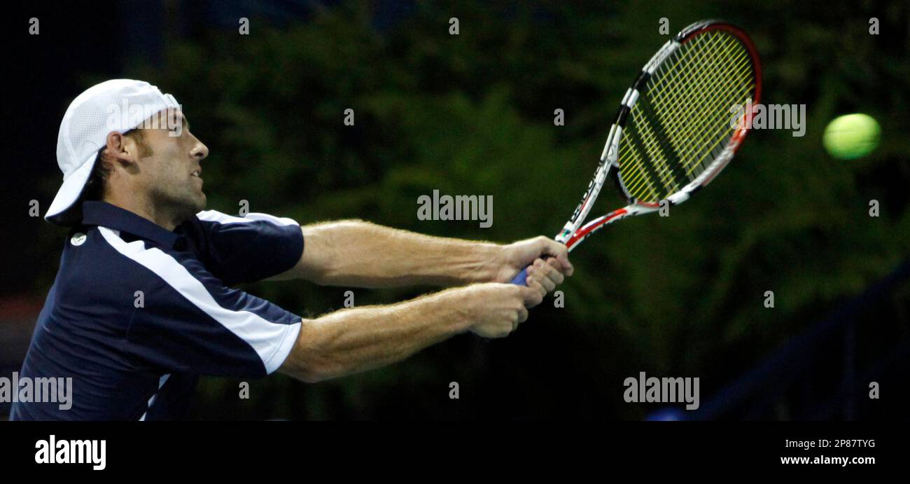 Robby Ginepri of the United States returns a shot against Russia's ...