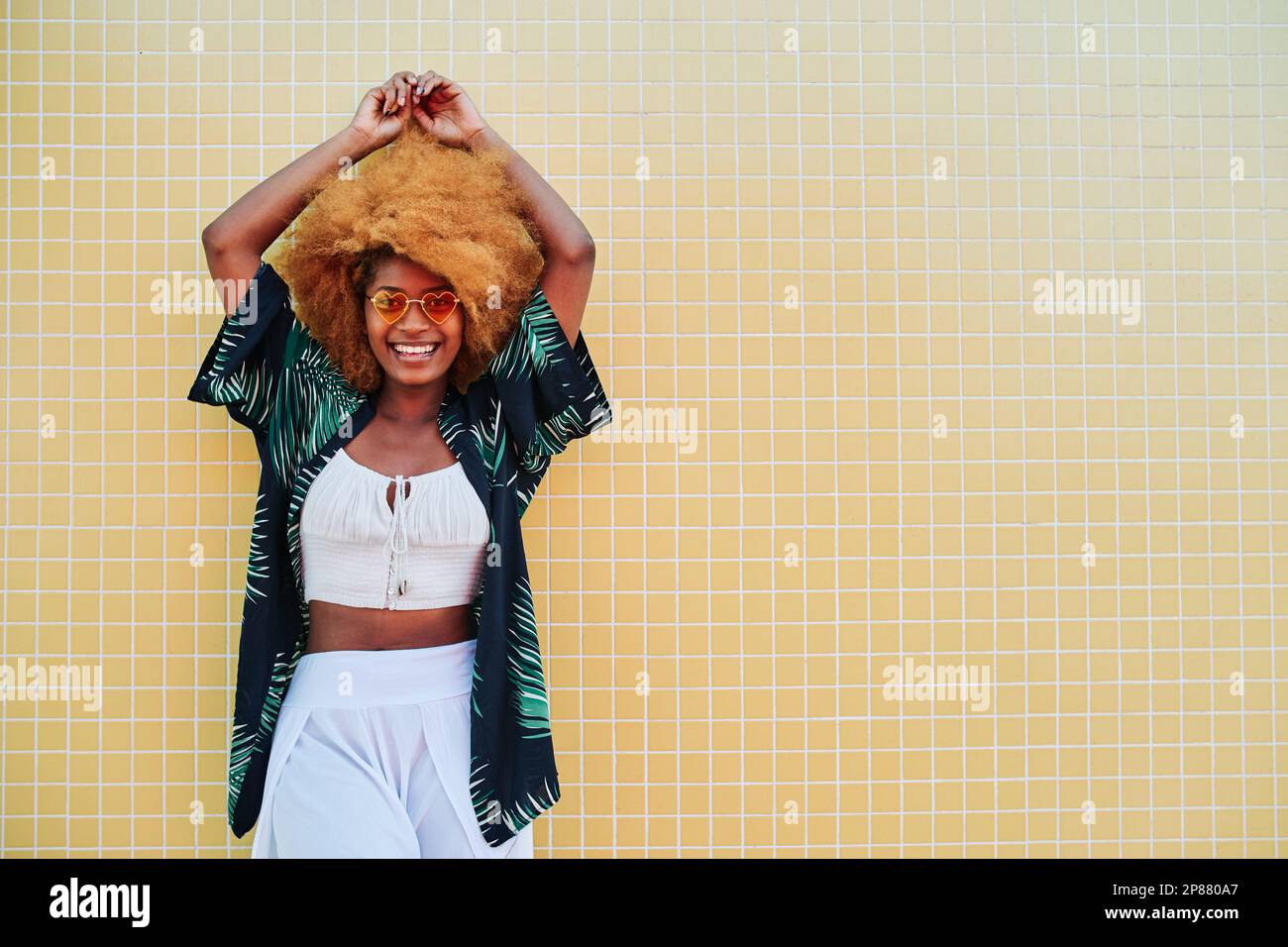 Modern afro woman smiling while posing with summer clothes Stock Photo ...