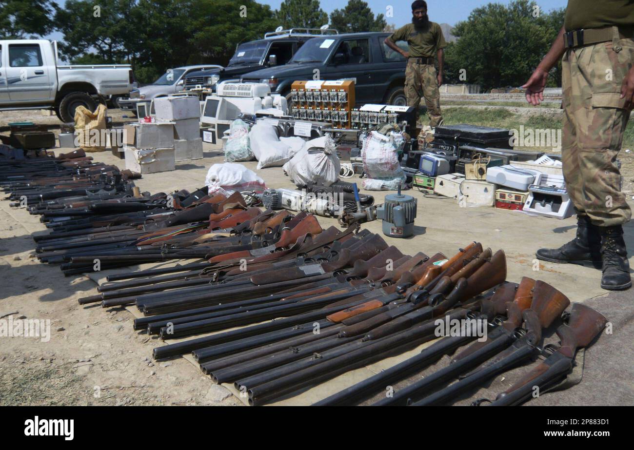 Pakistan army soldiers stand beside the weapons, computers, vehicle and ...