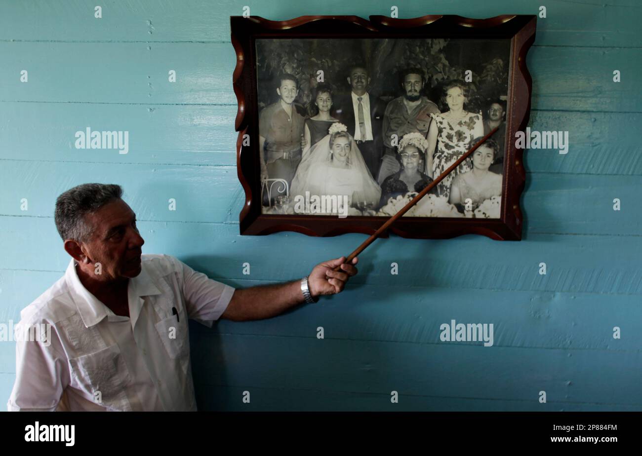 A man shows a photograph of Cuban leader Fidel Castro and his family ...
