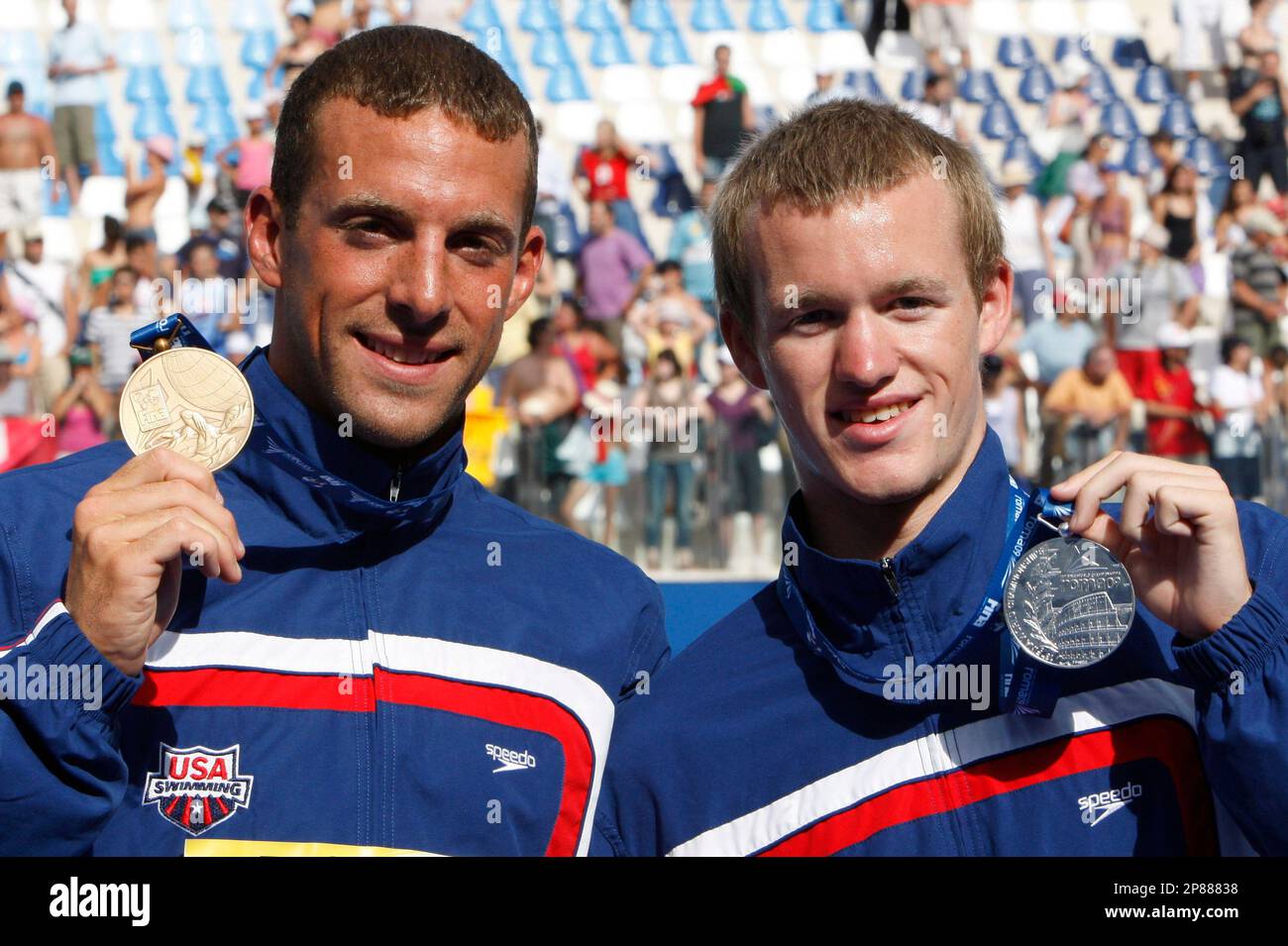 Andrew Gemmell of the United States, right, shows his silver medal of ...